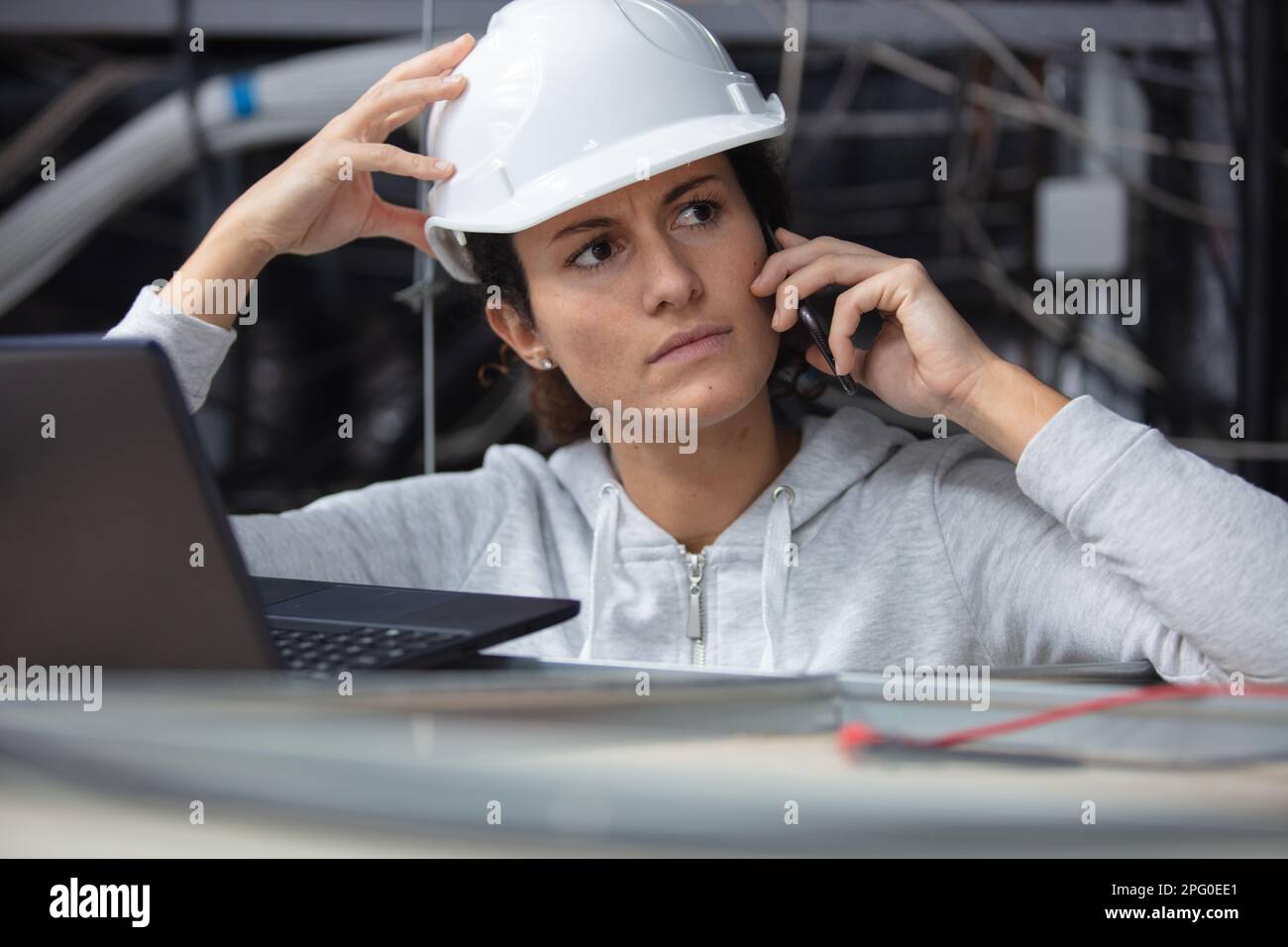 young woman builder pointing at ceiling indoors Stock Photo - Alamy