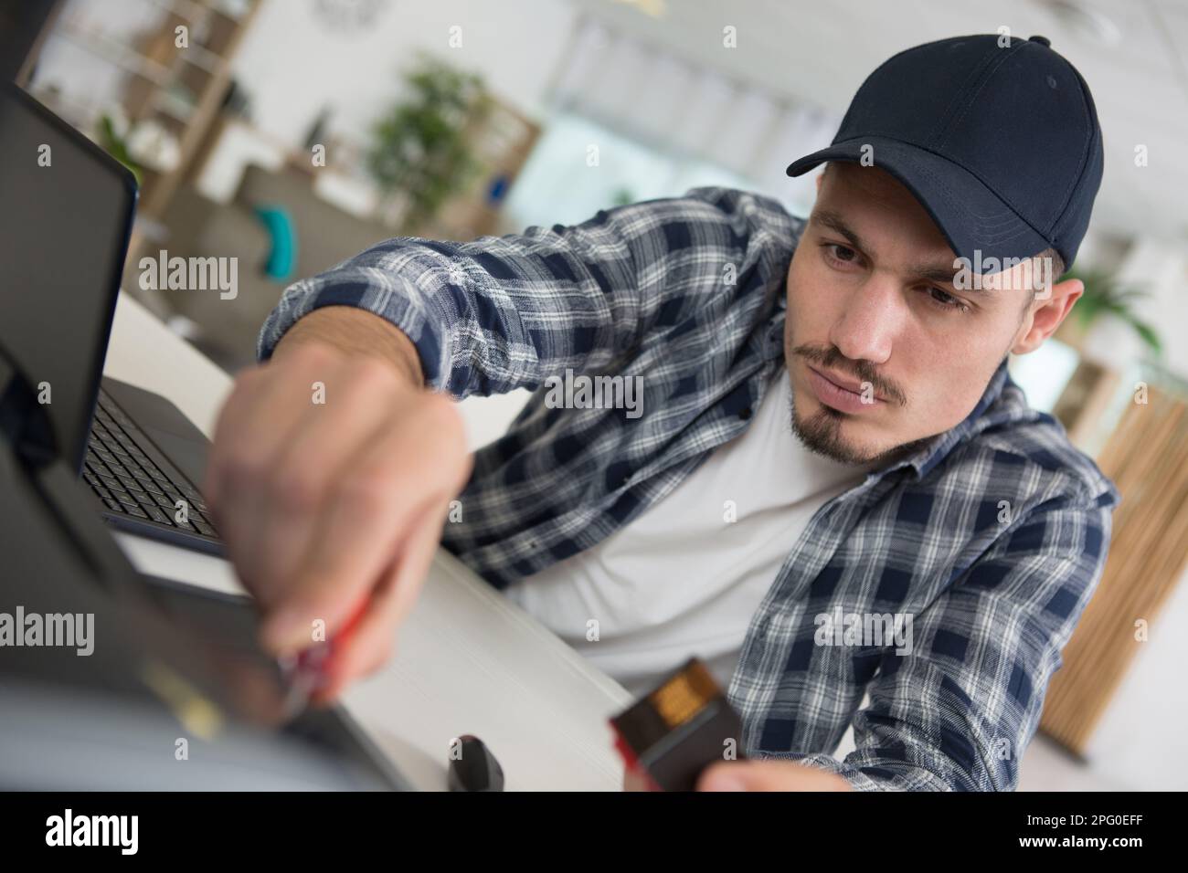 man repairing a laptop using screw driver Stock Photo - Alamy