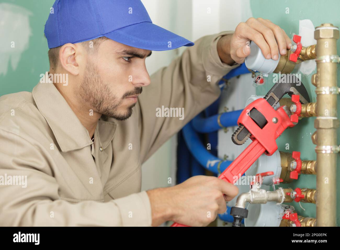a man is fixing a water meter Stock Photo - Alamy