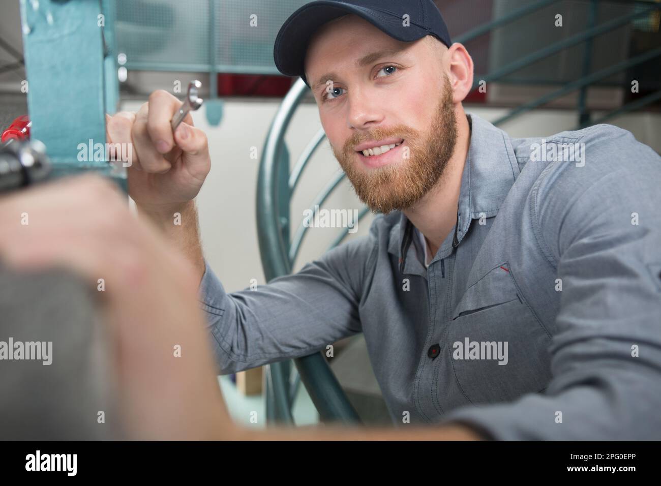 portrait of a male engineer using a spanner Stock Photo - Alamy
