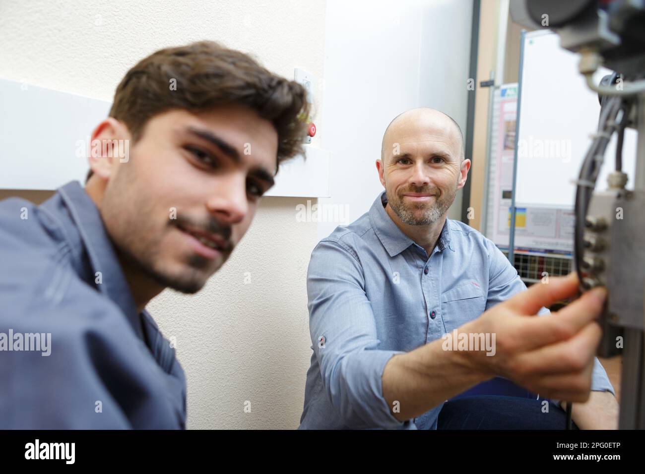 technical engineer posing with teacher Stock Photo - Alamy