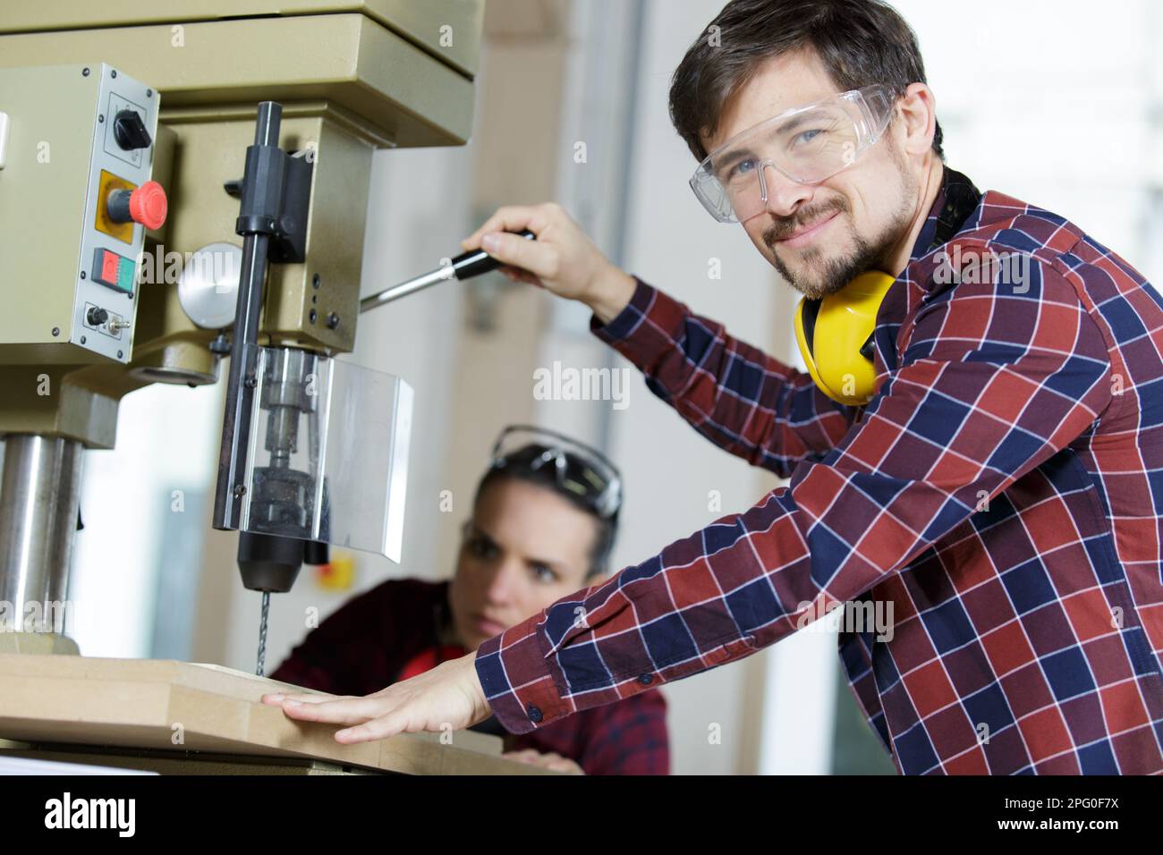 happy man drills in the drilling machine Stock Photo - Alamy