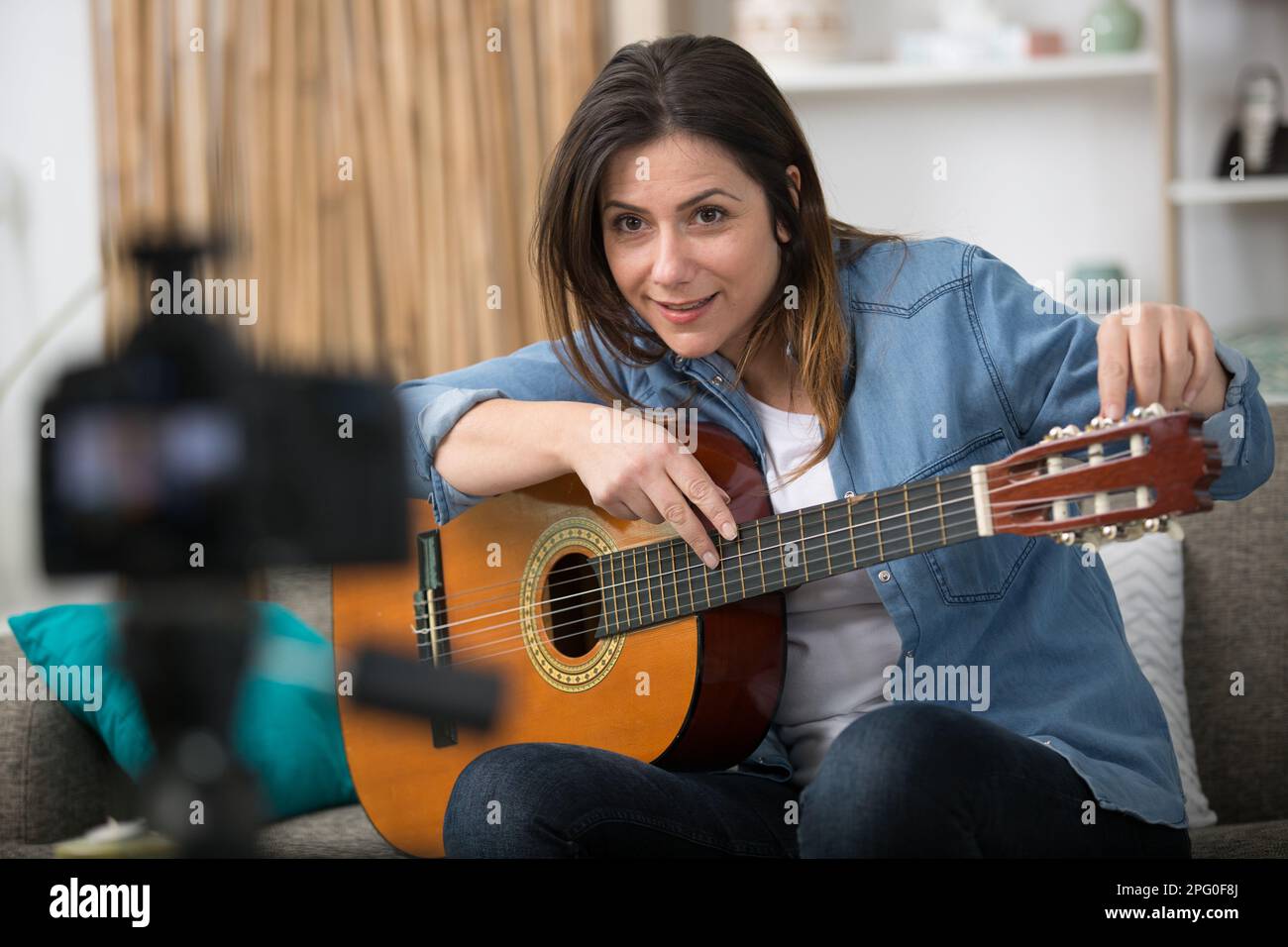 Woman playing guitar filming hi-res stock photography and images - Alamy