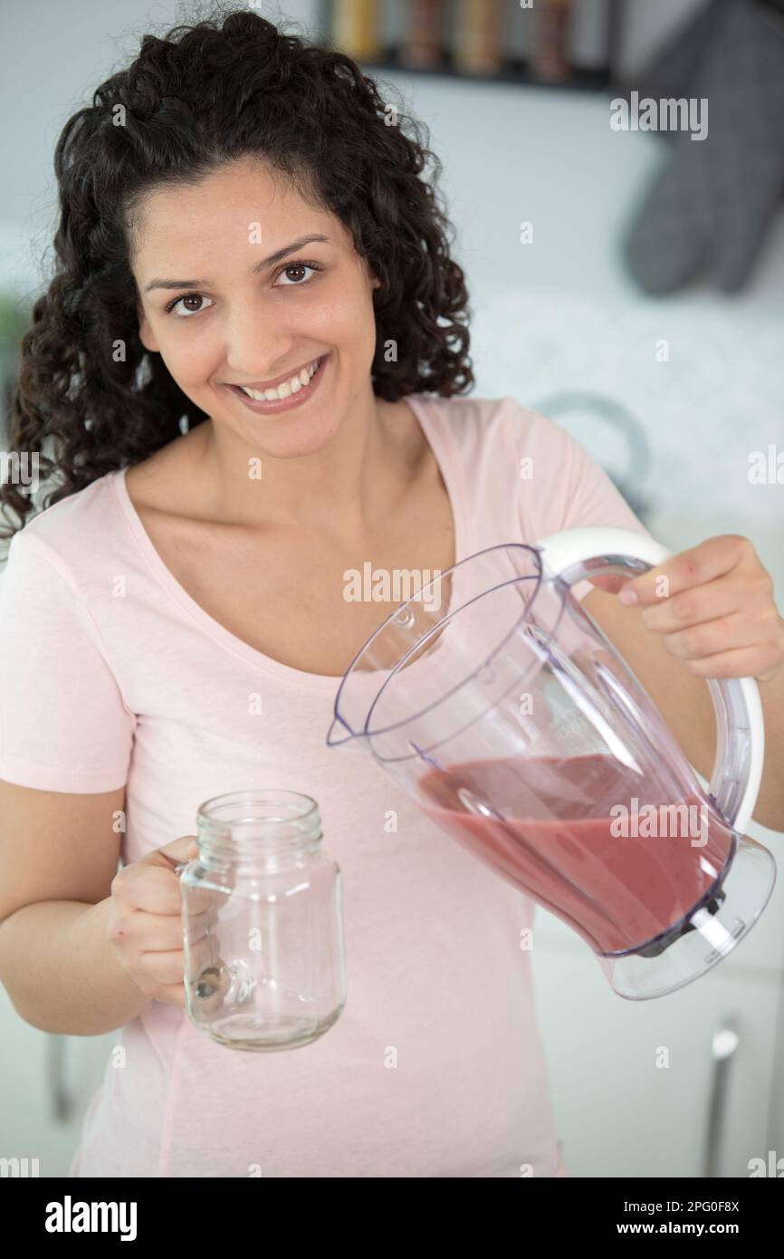 Woman pouring juice into glass hi-res stock photography and images - Alamy