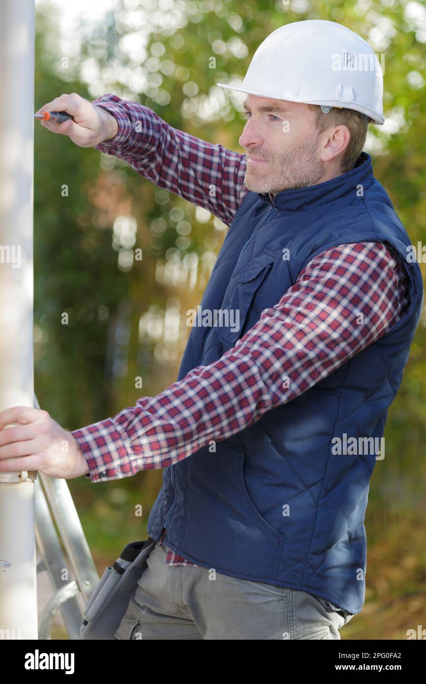 builder screwing outdoors Stock Photo - Alamy