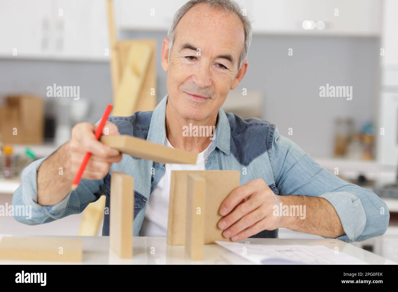 senior man assembling wooden furniture Stock Photo - Alamy