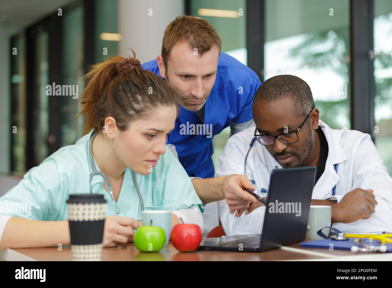 group of doctors in the cafeteria or canteen eating Stock Photo - Alamy