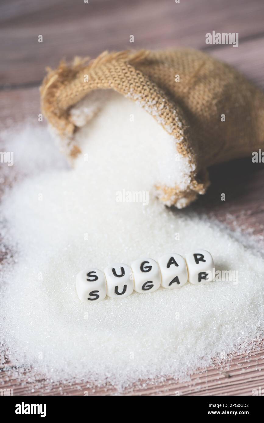 Sugar on sack and wooden background, white sugar for food and sweets ...