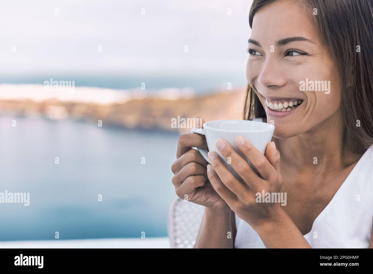 Breakfast coffee girl drinking coffee cup in the morning looking at Mediterranean sea view from ...