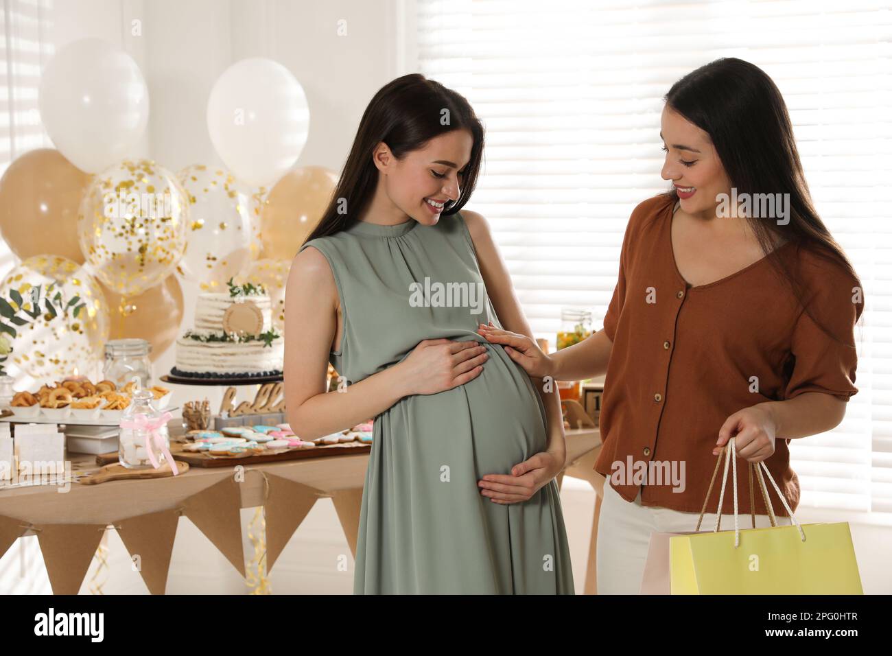 Happy pregnant woman with friend at baby shower party Stock Photo - Alamy