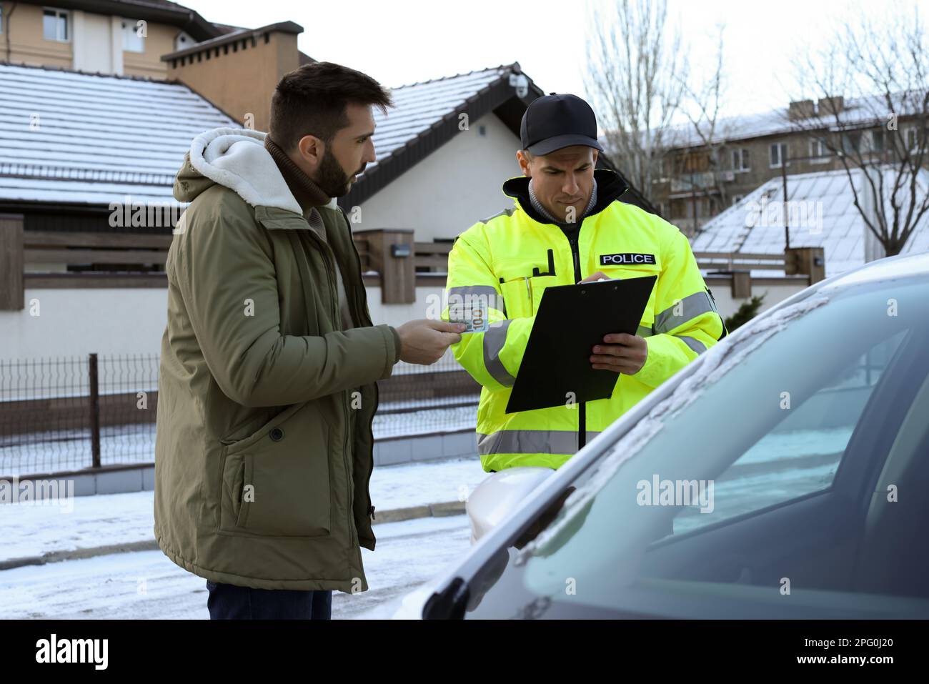 Man giving bribe to police officer near car outdoors Stock Photo - Alamy