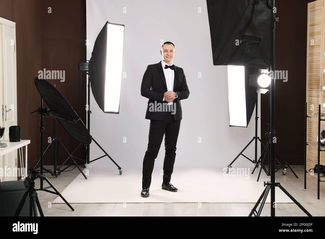 Handsome model posing in studio. Professional photo session Stock Photo ...