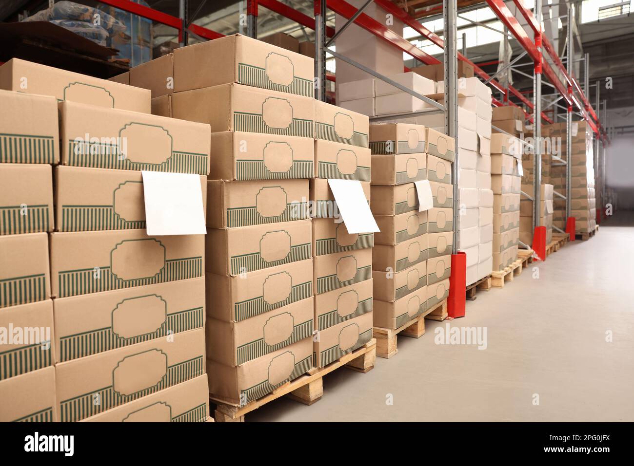 Warehouse with stacks of boxes on wooden pallets. Wholesaling Stock ...