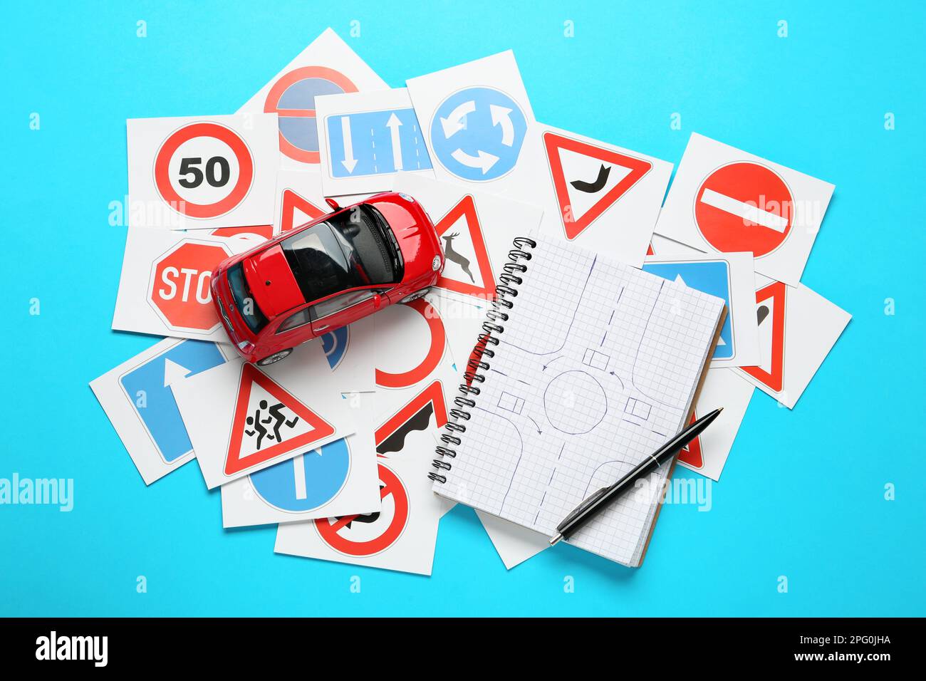 Many different road sign cards, notebook with sketch of roundabout and ...