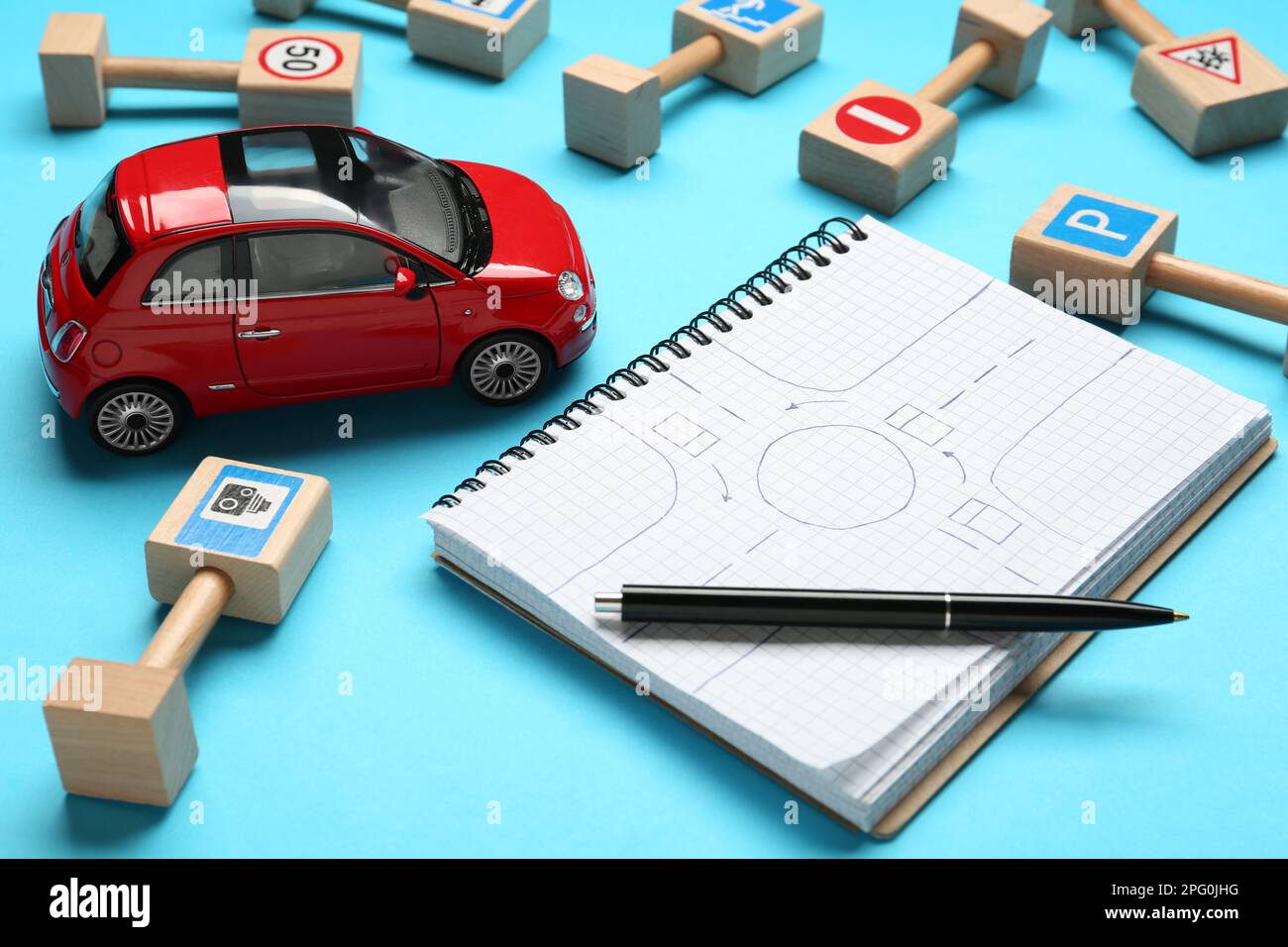 Many different miniature road signs, notebook with sketch of roundabout ...