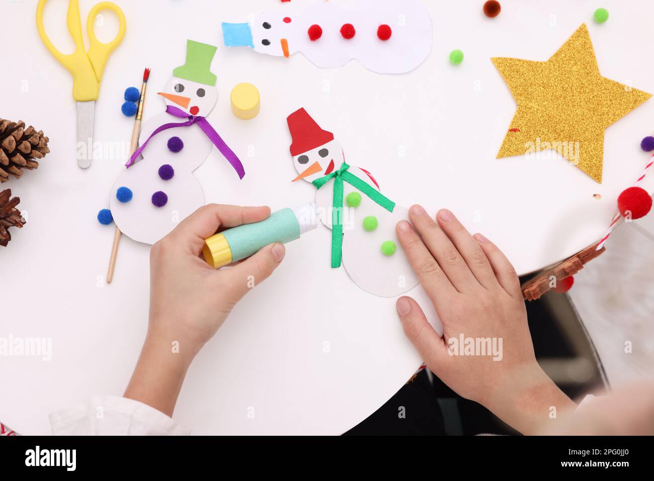 Little child making Christmas craft at white table, top view Stock ...