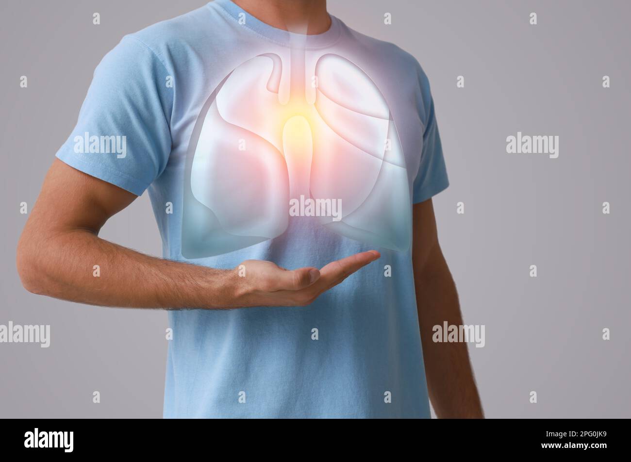 Man holding hand near chest with illustration of lungs on grey ...