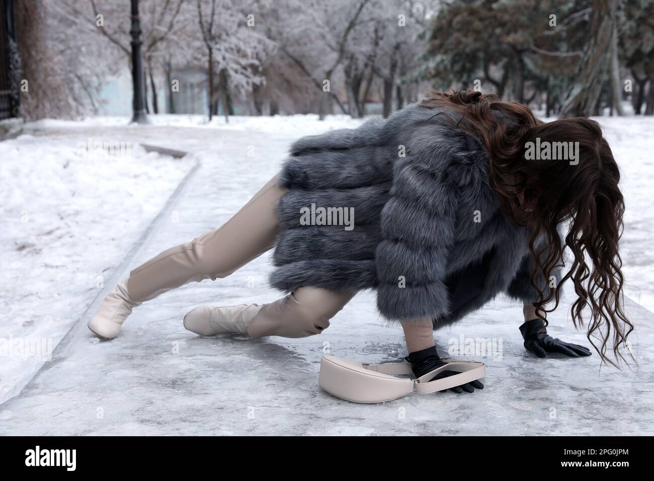 Young woman fallen on slippery icy pavement in park Stock Photo - Alamy