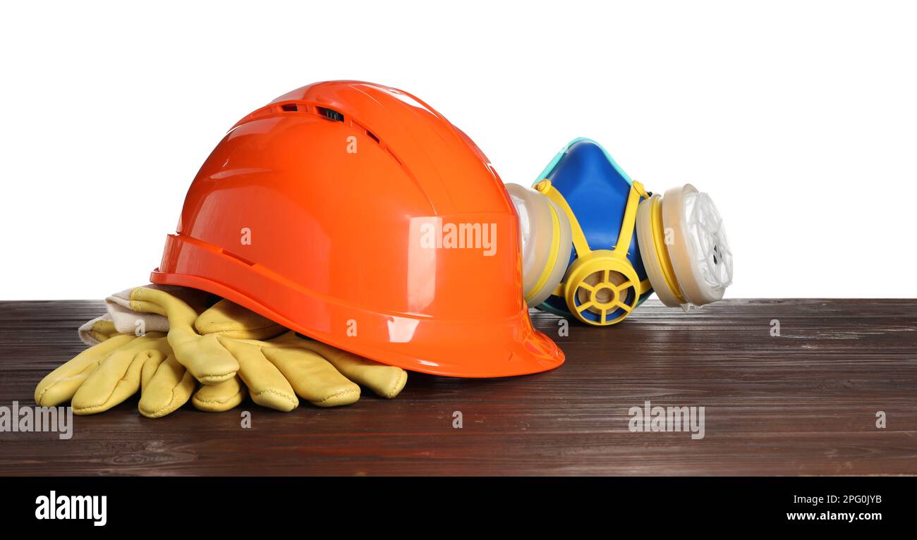 Personal protective equipment on wooden surface against white ...