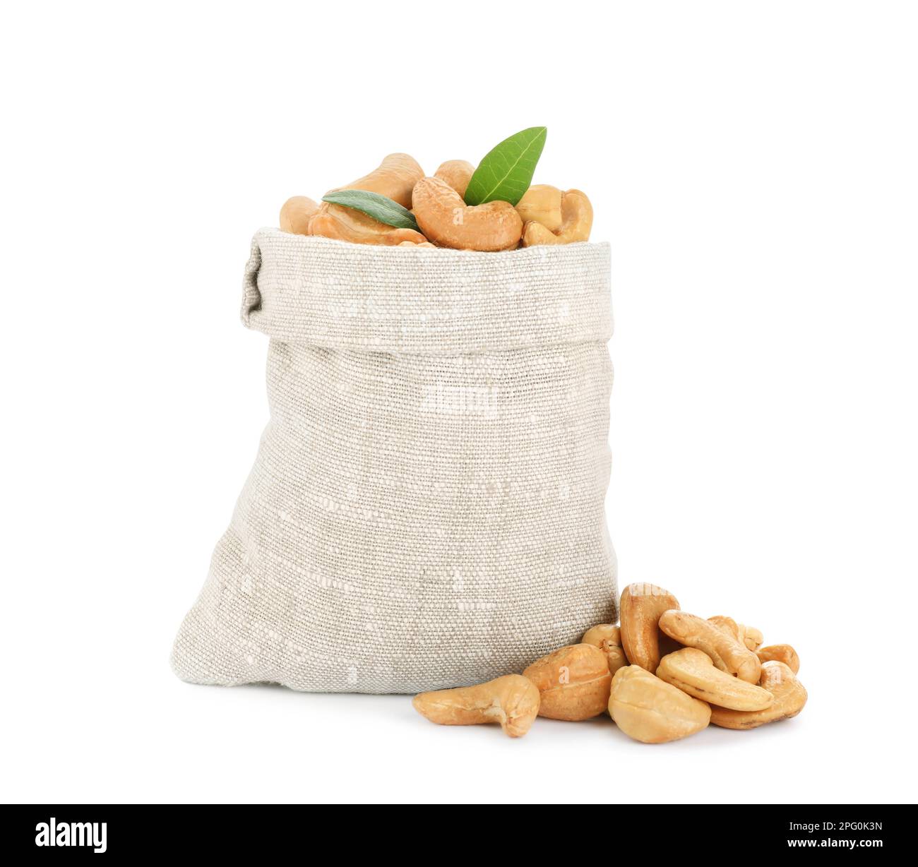 Sack, tasty organic cashew nuts and green leaves isolated on white ...