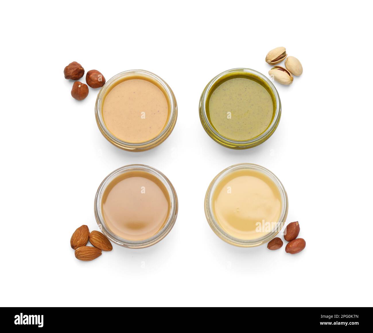 Different types of delicious nut butters and ingredients on white ...