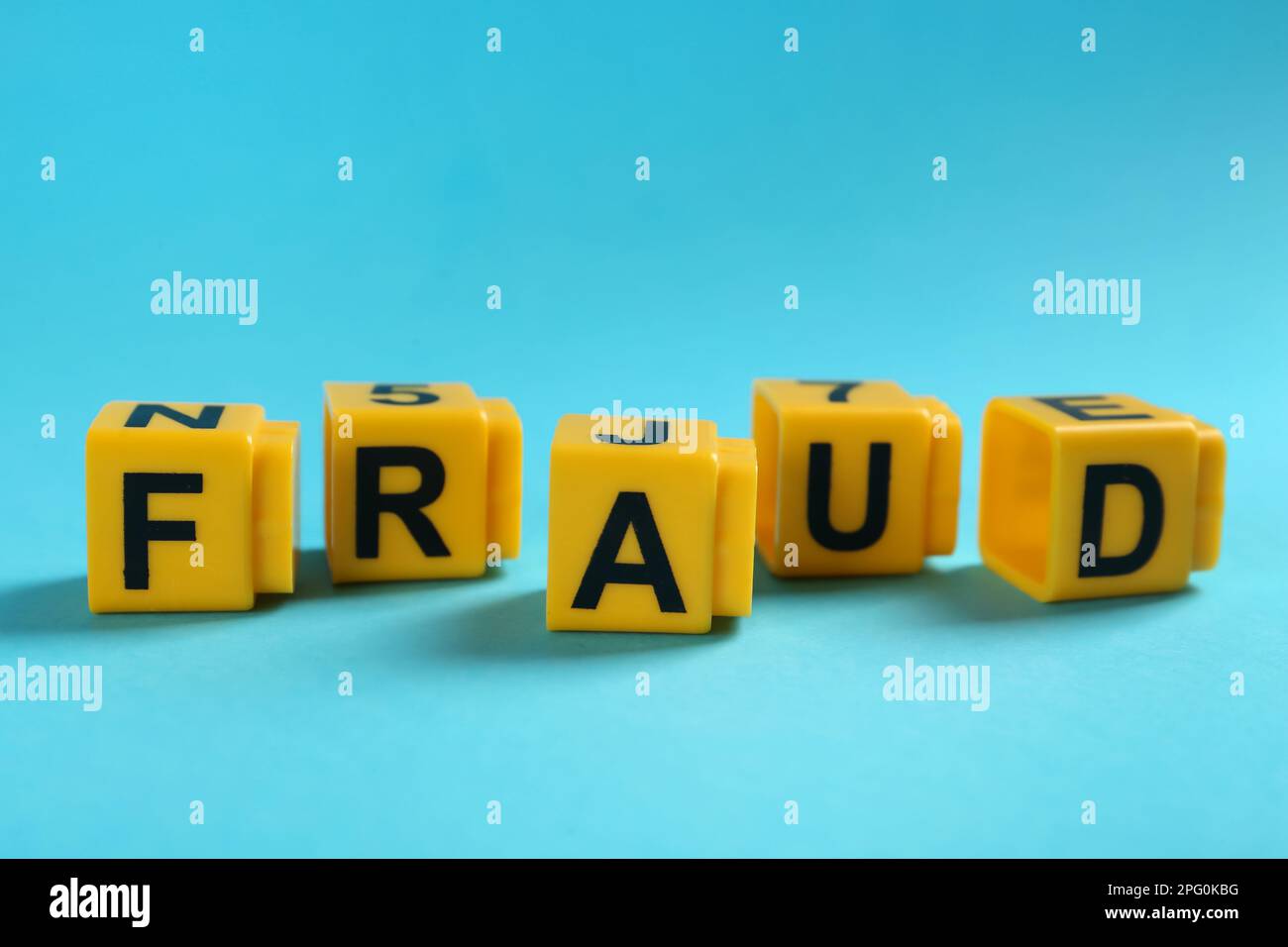 Word Fraud of yellow cubes with letters on light blue background Stock ...