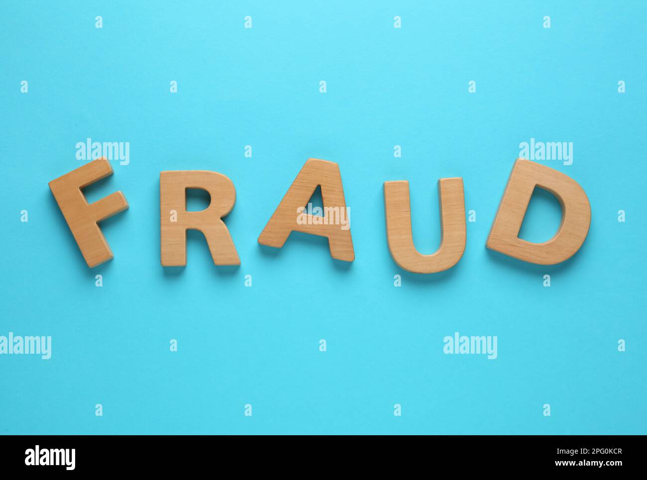 Word Fraud made of wooden letters on light blue background, flat lay ...