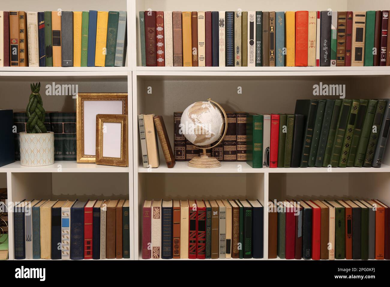 Collection of different books and decorative elements on shelves in ...