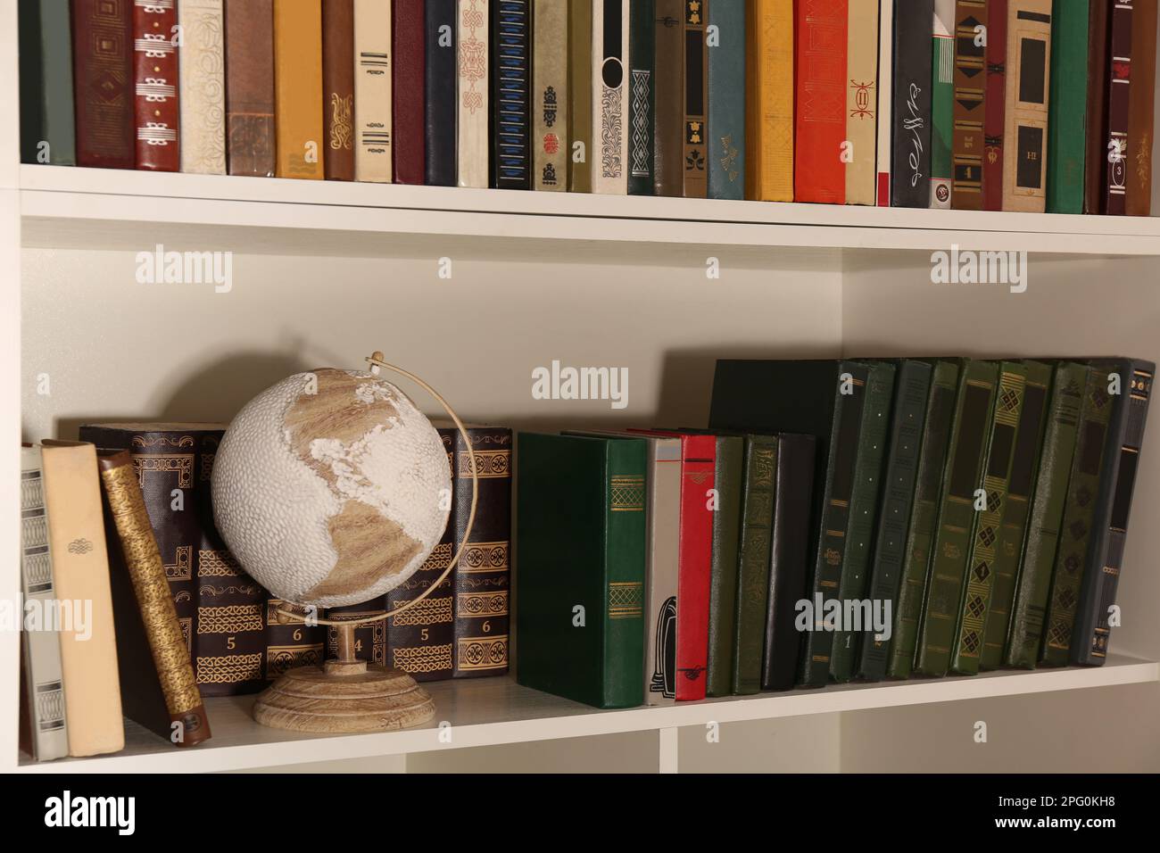 Collection of different books and decorative elements on shelves in ...