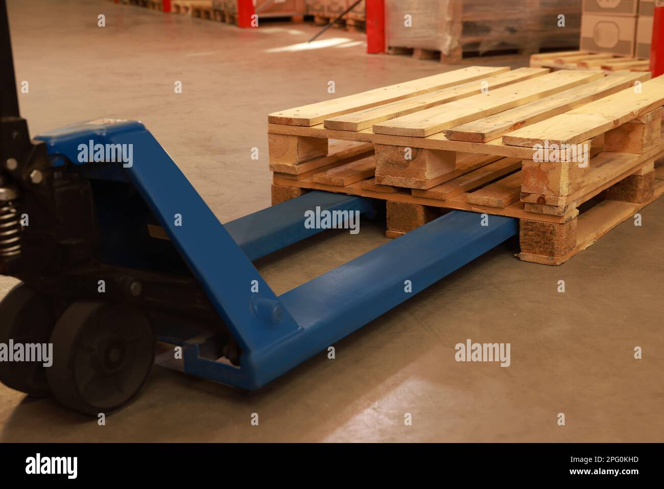 Modern manual forklift with wooden pallets in warehouse, closeup Stock ...
