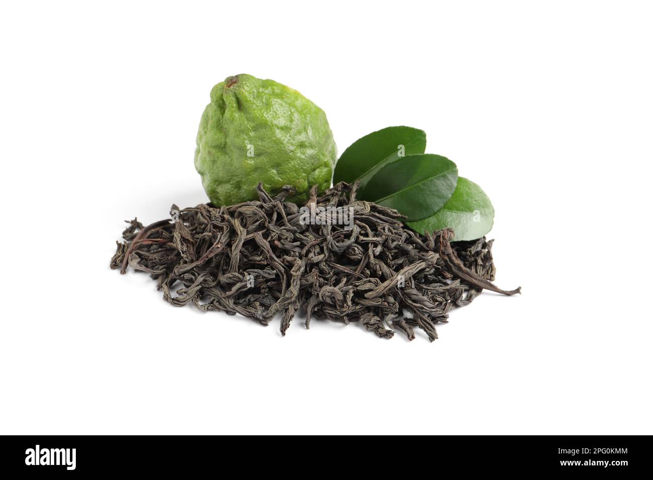 Pile of dry bergamot tea leaves and fresh fruit on white background ...