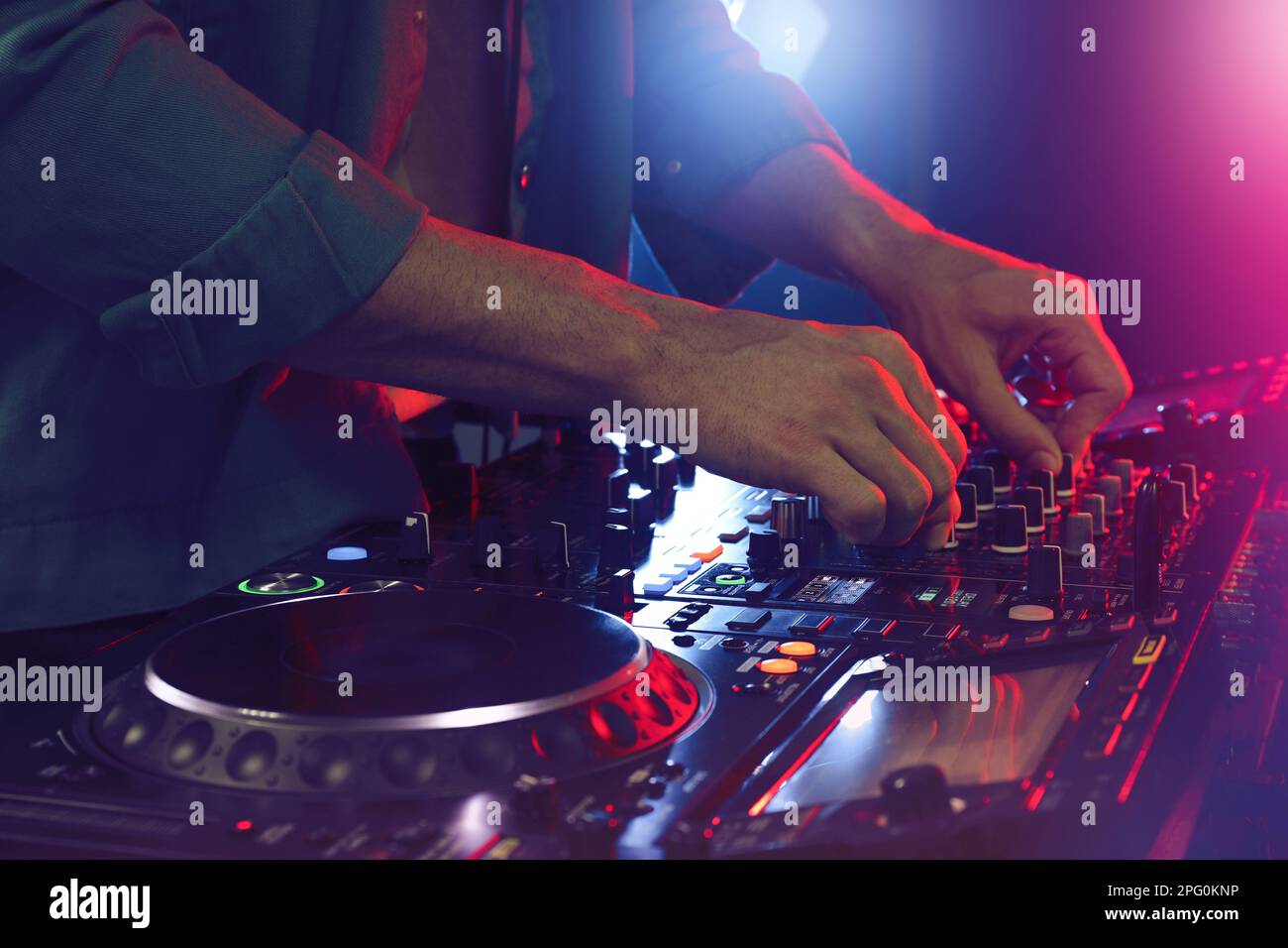 DJ creating music on modern console mixer in night club, closeup Stock ...
