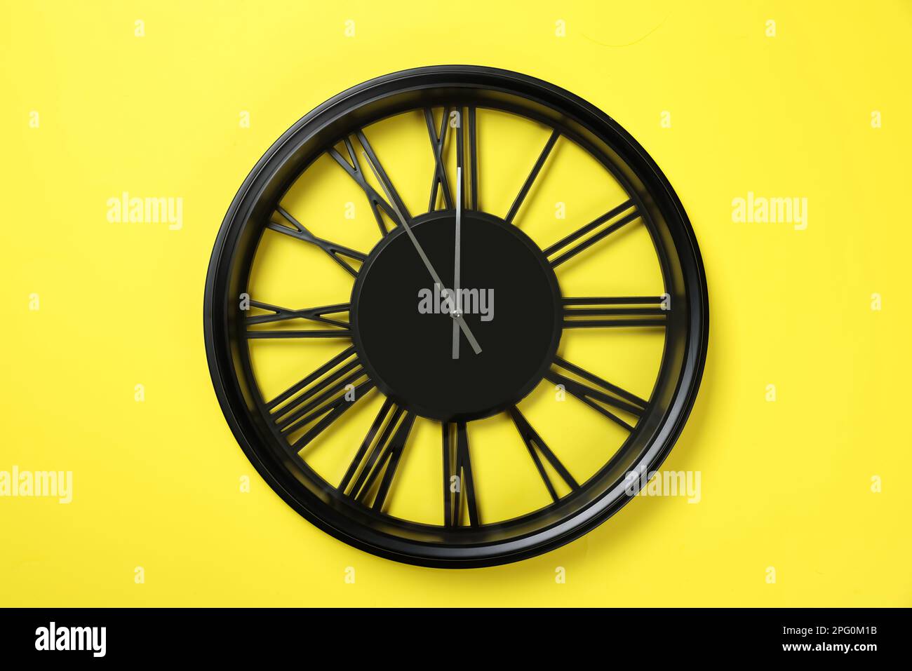 Clock showing five minutes until midnight on yellow background. New ...