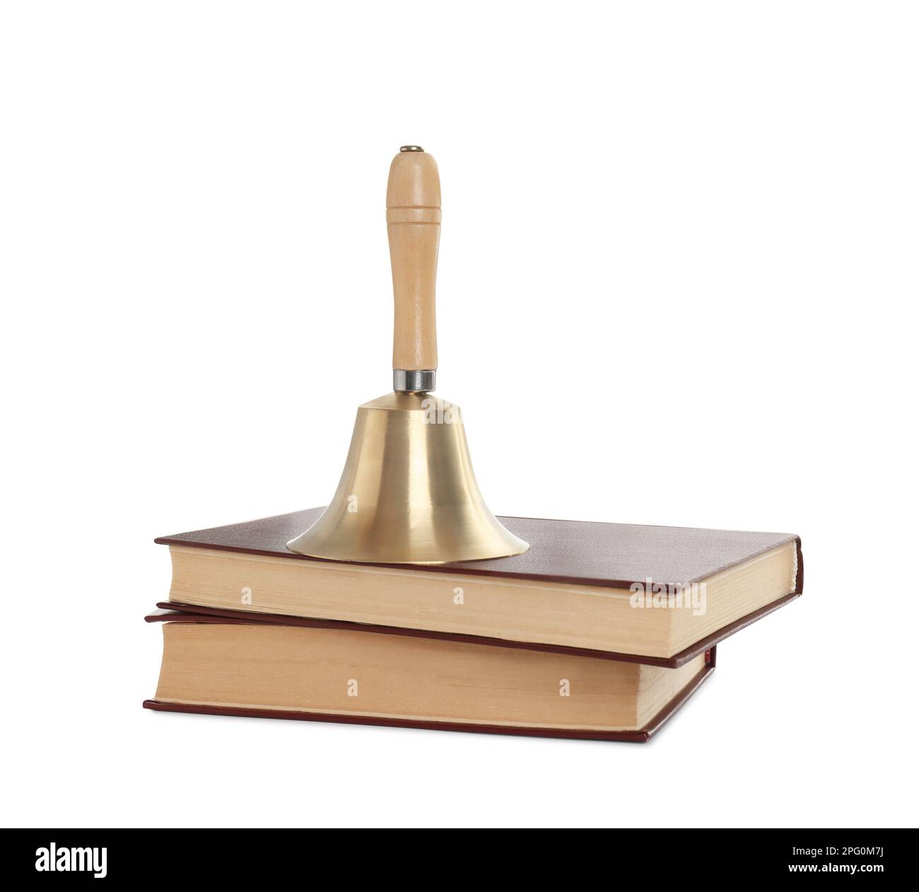 Golden school bell with wooden handle and books on white background ...