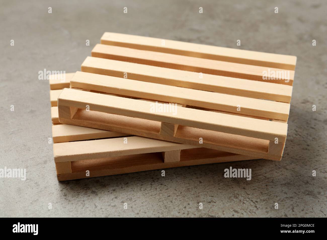 Two small wooden pallets on light grey table Stock Photo - Alamy