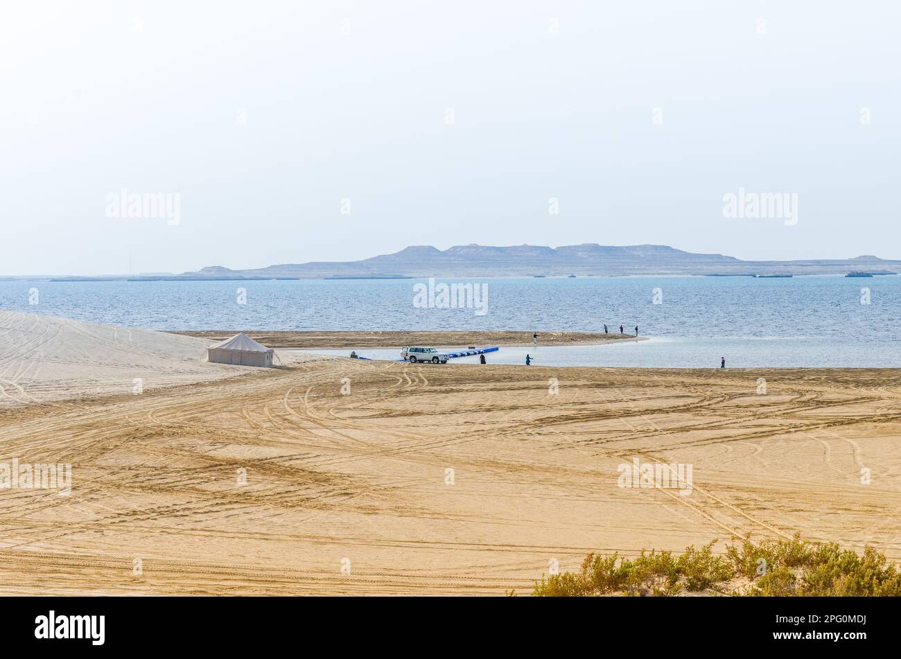 Sand dunes descending into the creek with limestone hills in the ...