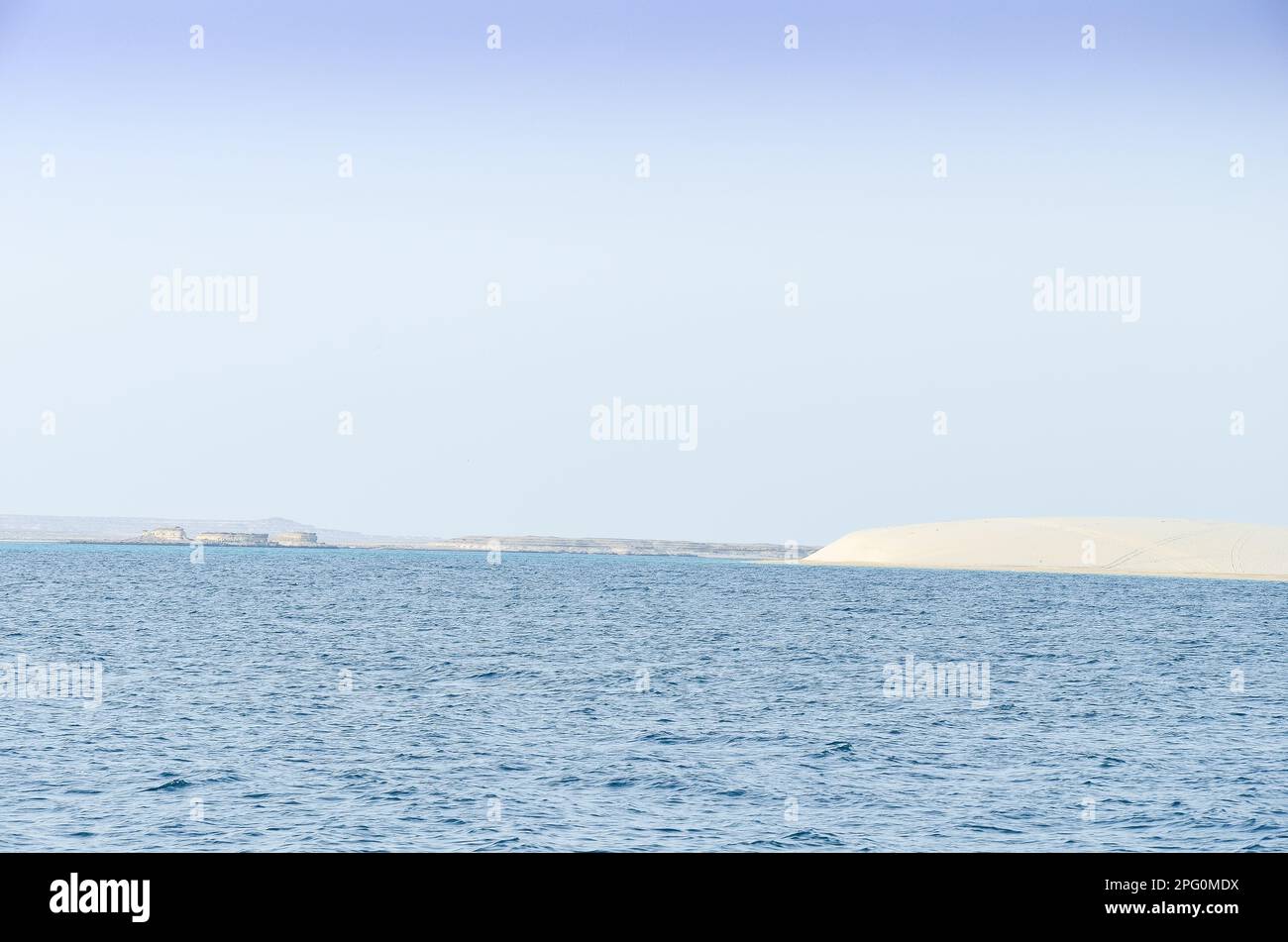 Sand dunes descending into the creek with limestone hills in the ...