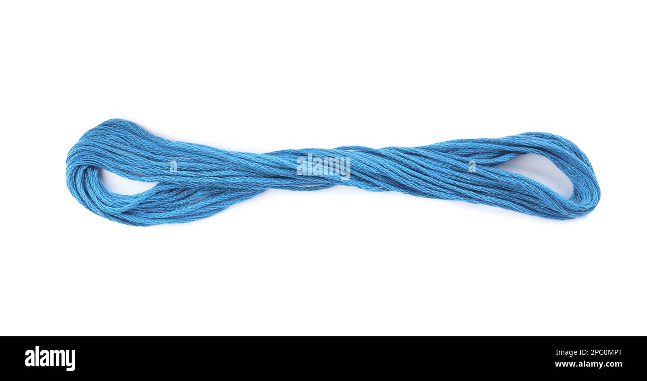 Light blue embroidery thread on white background Stock Photo - Alamy