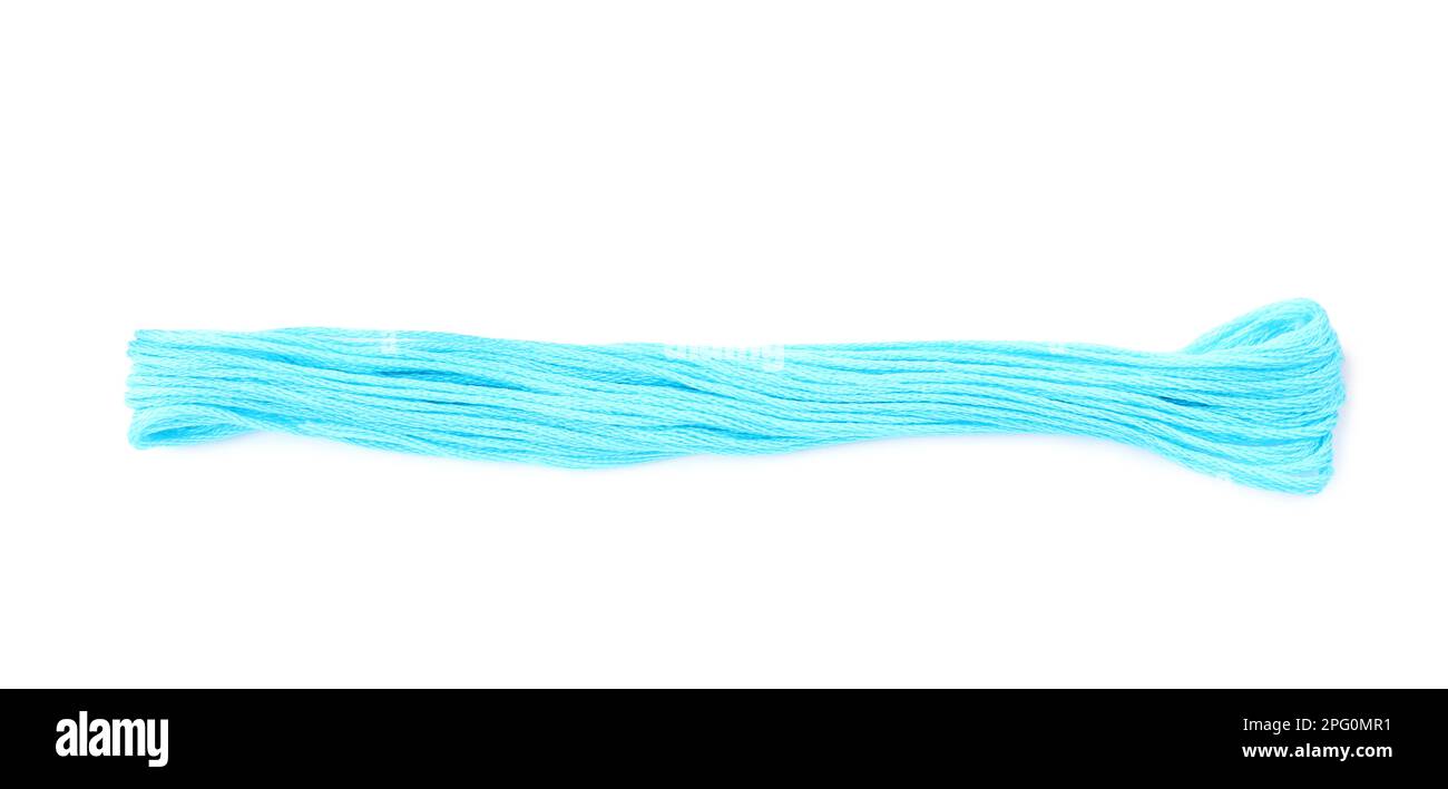 Light blue embroidery thread on white background Stock Photo - Alamy