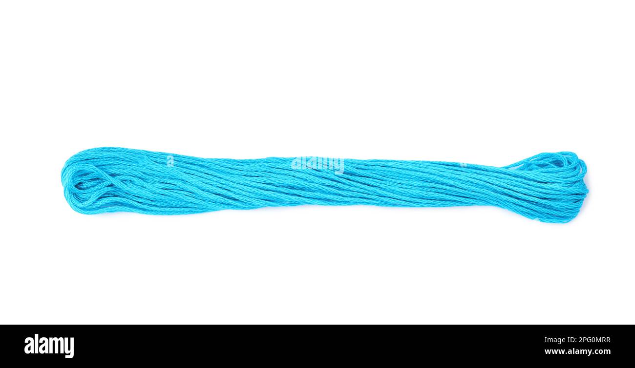 Light blue embroidery thread on white background Stock Photo - Alamy