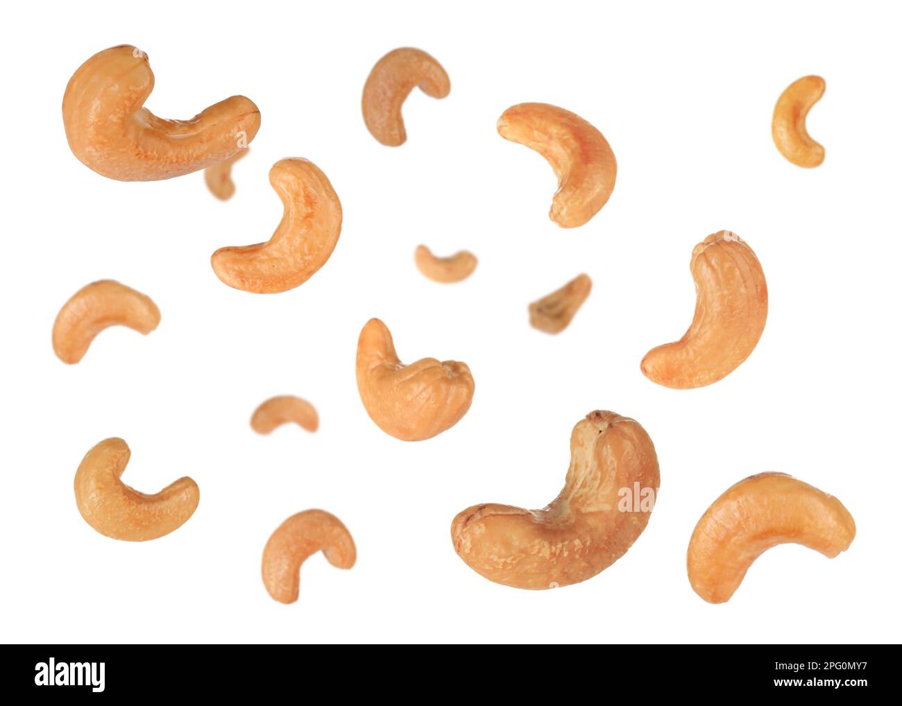 Tasty roasted cashew nuts falling on white background Stock Photo - Alamy