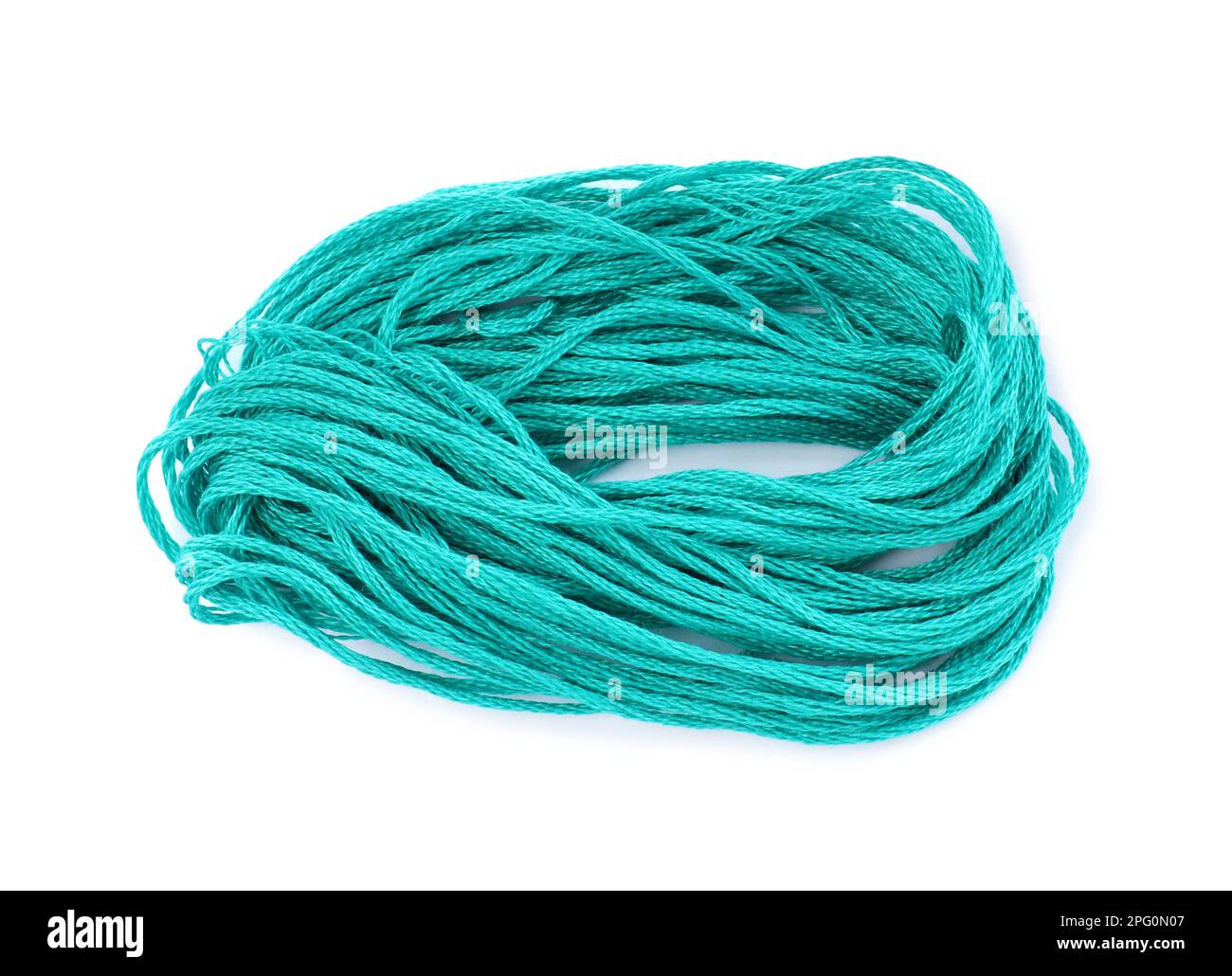 Bright turquoise embroidery thread on white background Stock Photo - Alamy