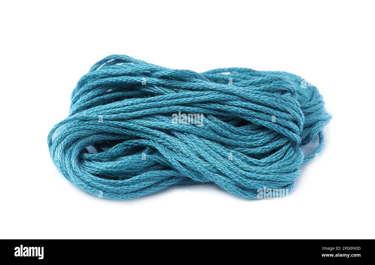 Light blue embroidery thread on white background Stock Photo - Alamy