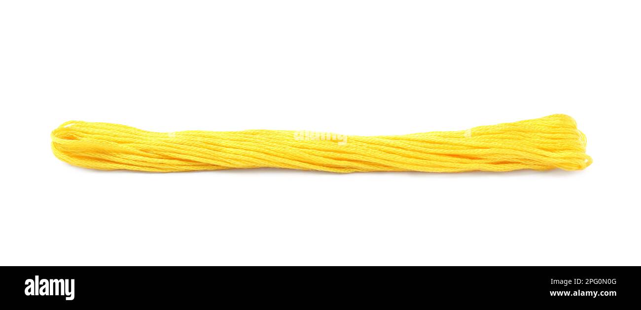 Bright yellow embroidery thread on white background Stock Photo - Alamy