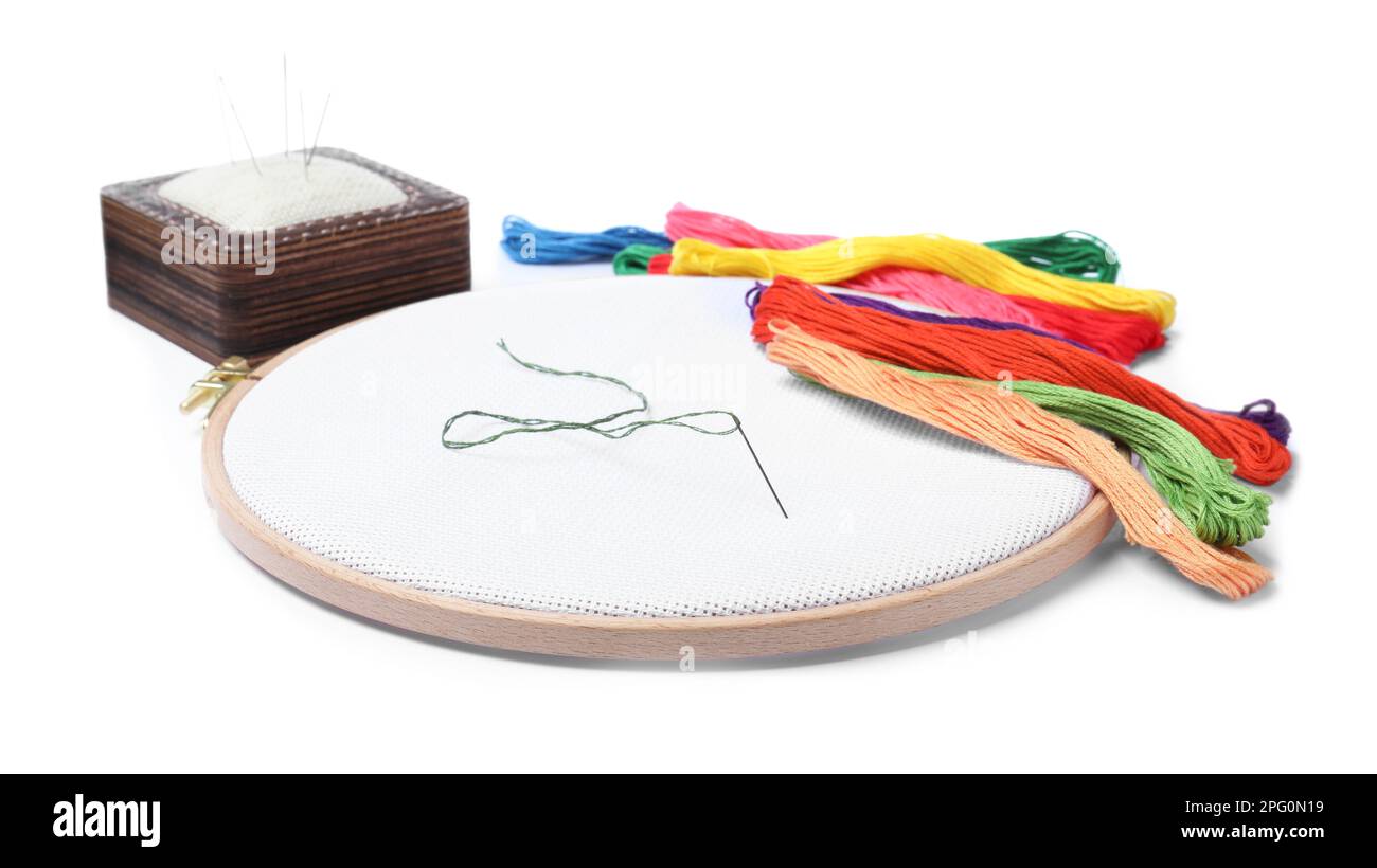 Colorful threads and different embroidery accessories on white ...