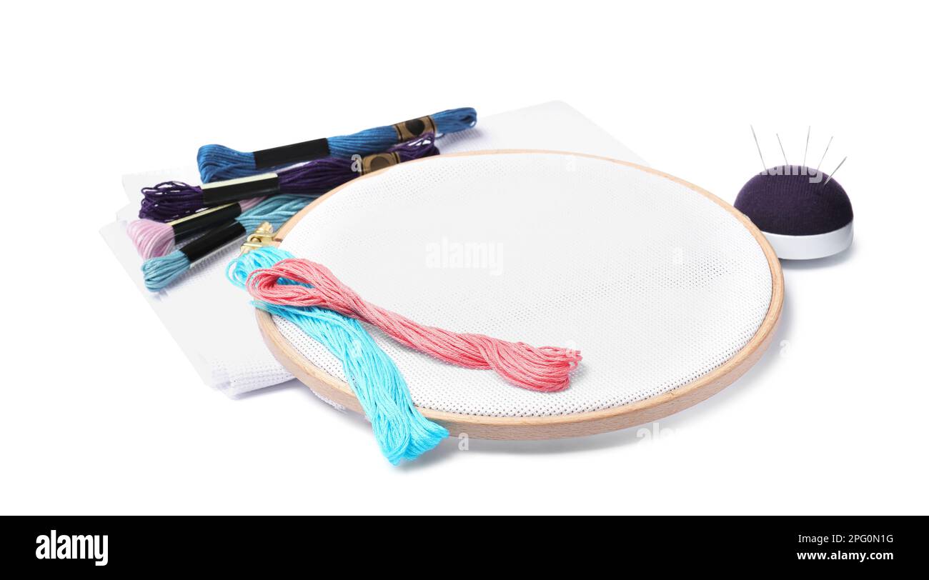 Colorful threads and different embroidery accessories on white ...