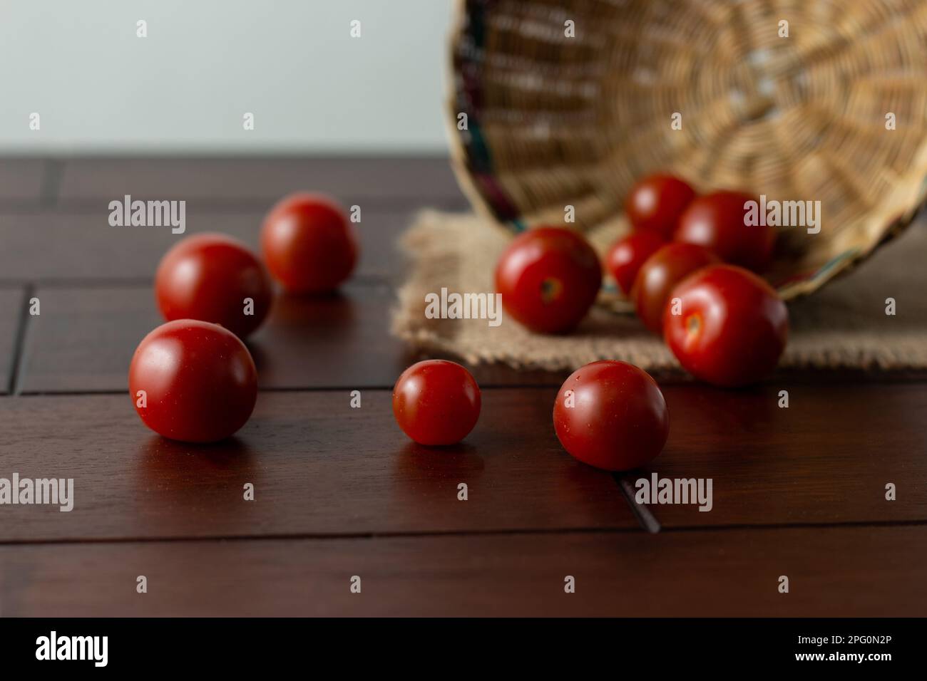 Cherry tomatoes on plate and wood background - Solanum lycopersicum var ...