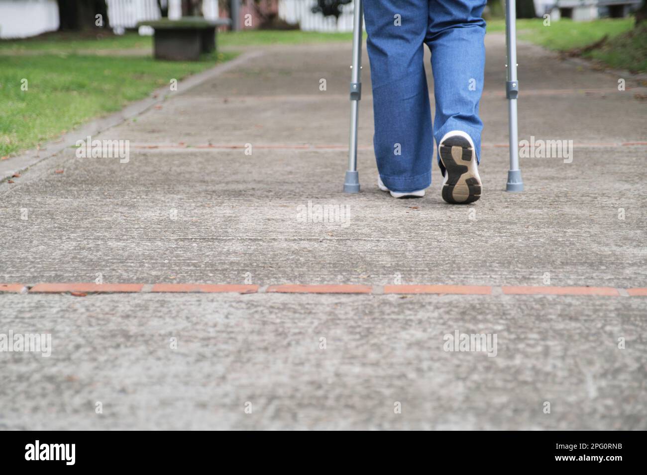 Unrecognizable person walking away from the camera with the help of ...