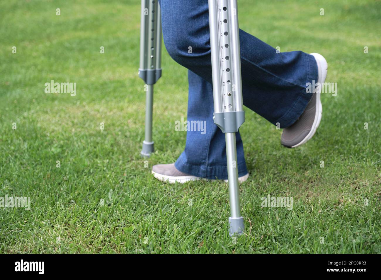 Detail of the legs and feet of an unrecognizable person walking with ...