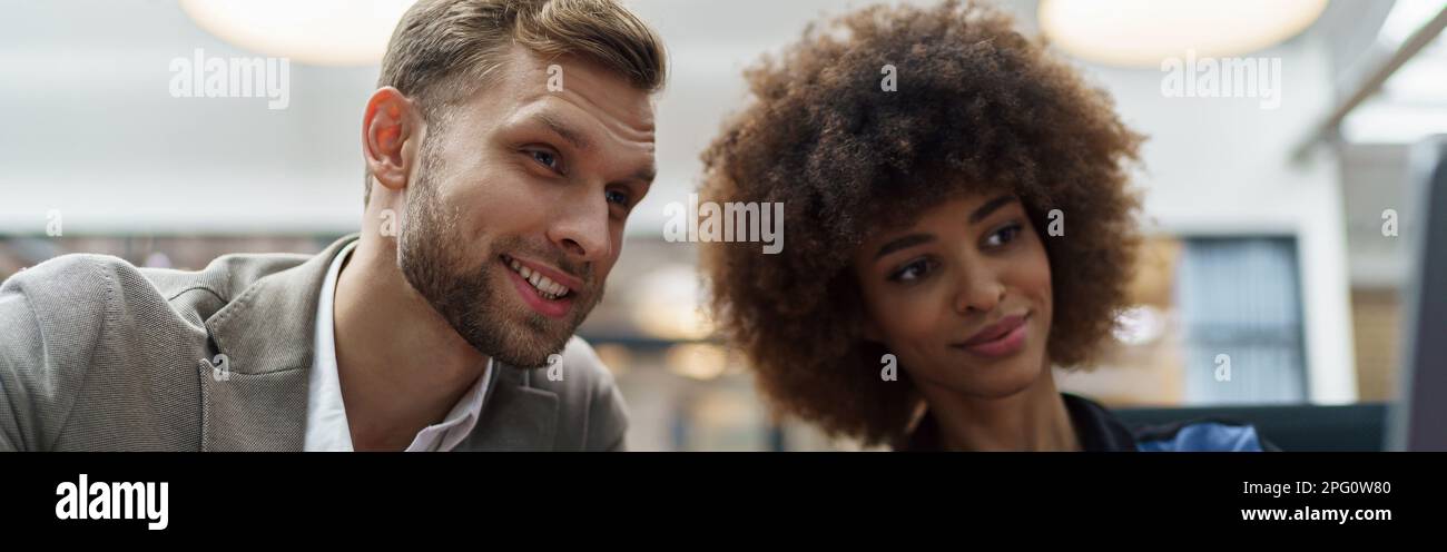 Two businesspartners working together in modern coworking and looking ...